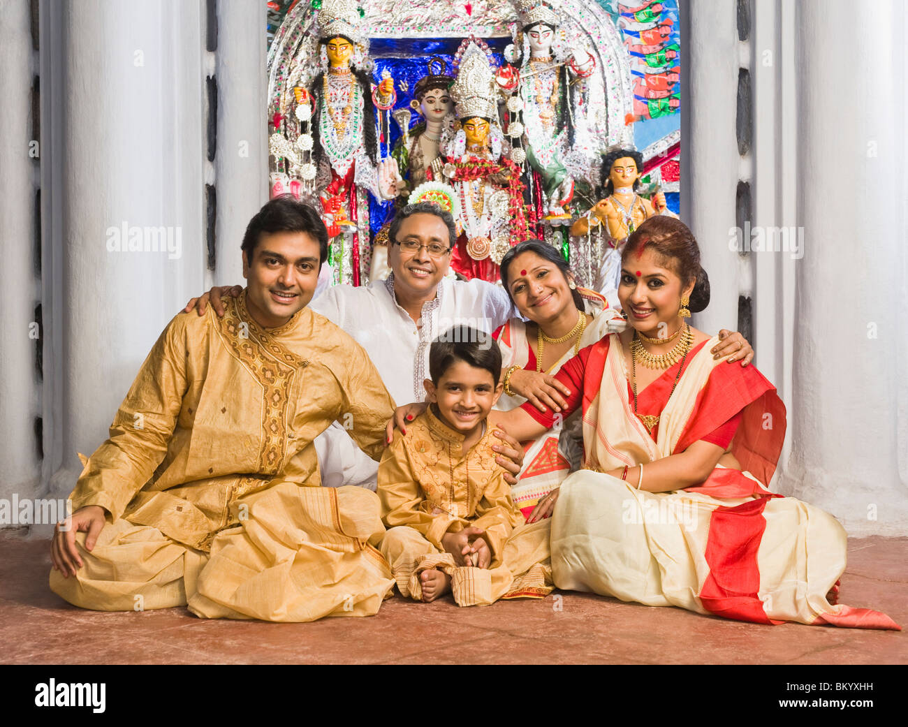 Family sitting in a temple Stock Photo - Alamy