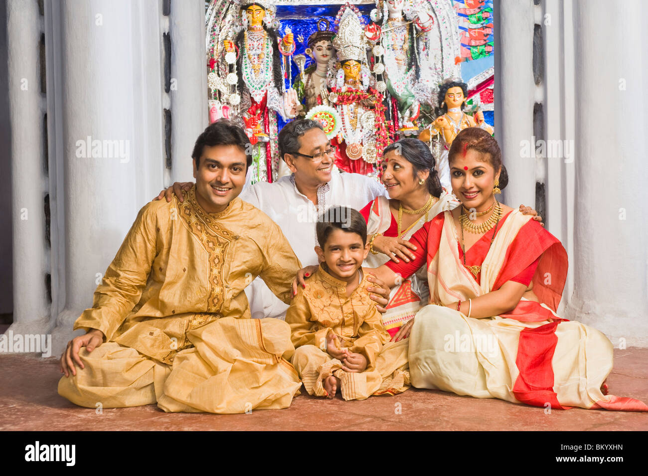 Family sitting in a temple Stock Photo - Alamy