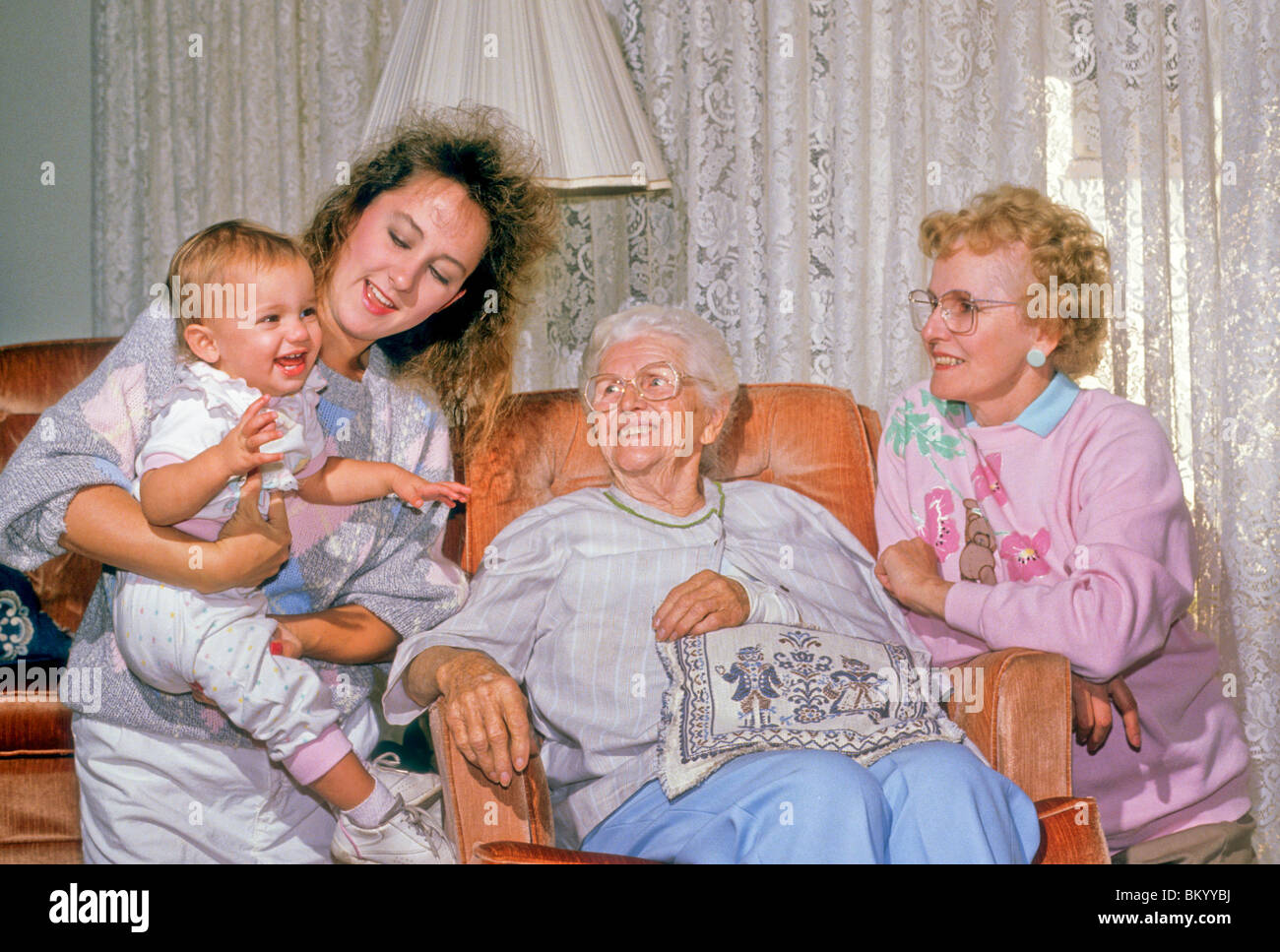Four generations of women smile and laugh together baby daughter hi-res ...