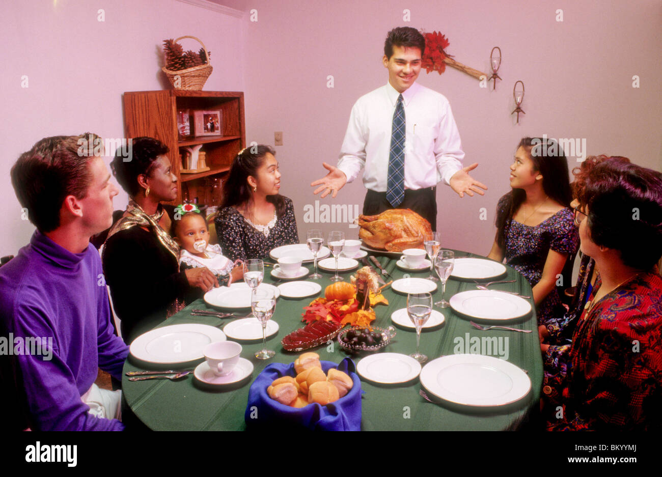 Mixed race group celebrates holiday Thanksgiving dinner meal share ...