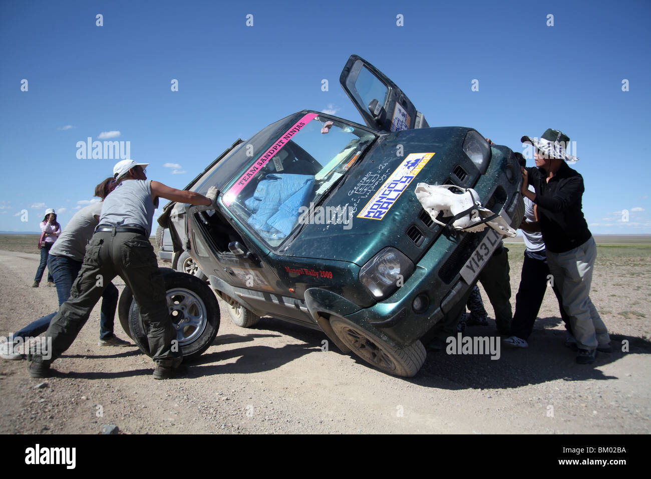 A Suzuki Jimny is rolled onto its side for repair during the 2009 ...