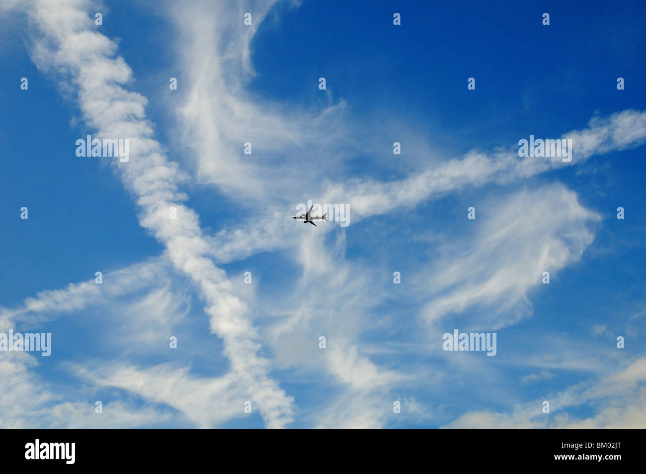 Passenger aircraft with contrails hi-res stock photography and images ...