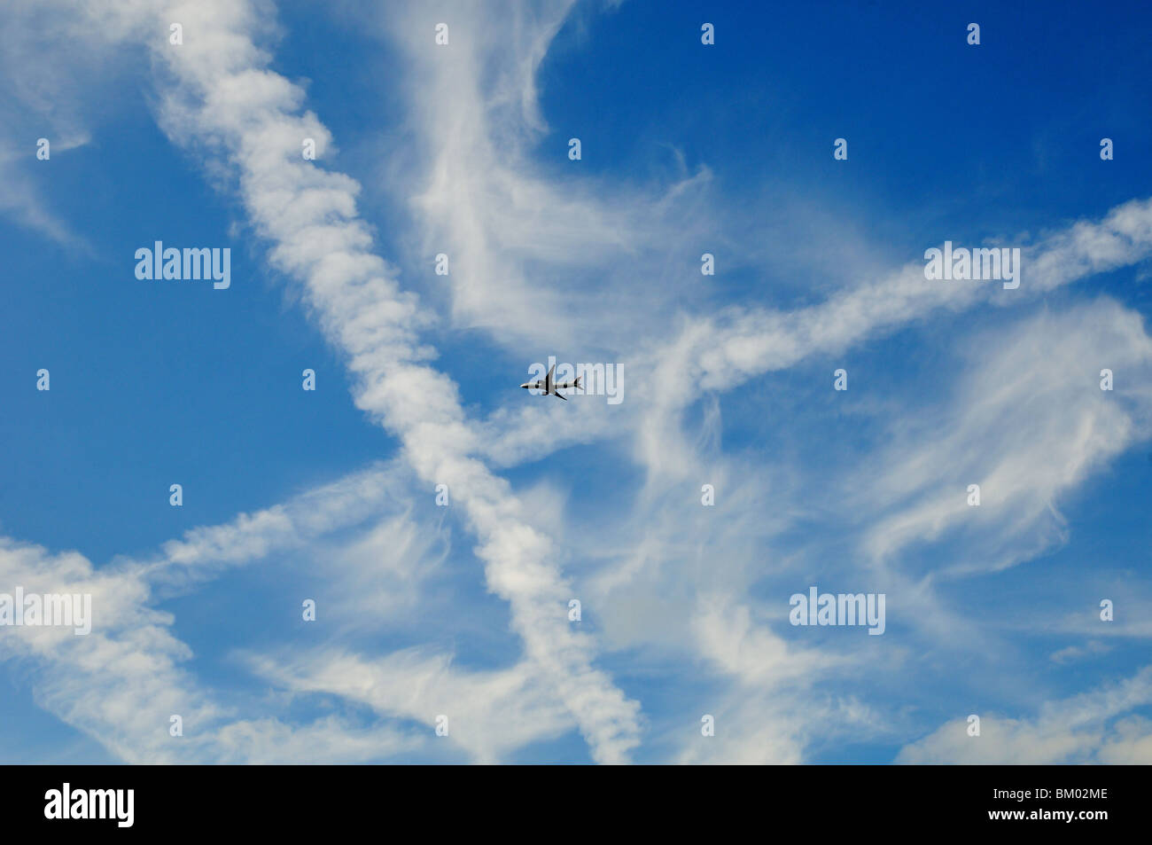 Passenger aircraft with contrails hi-res stock photography and images ...
