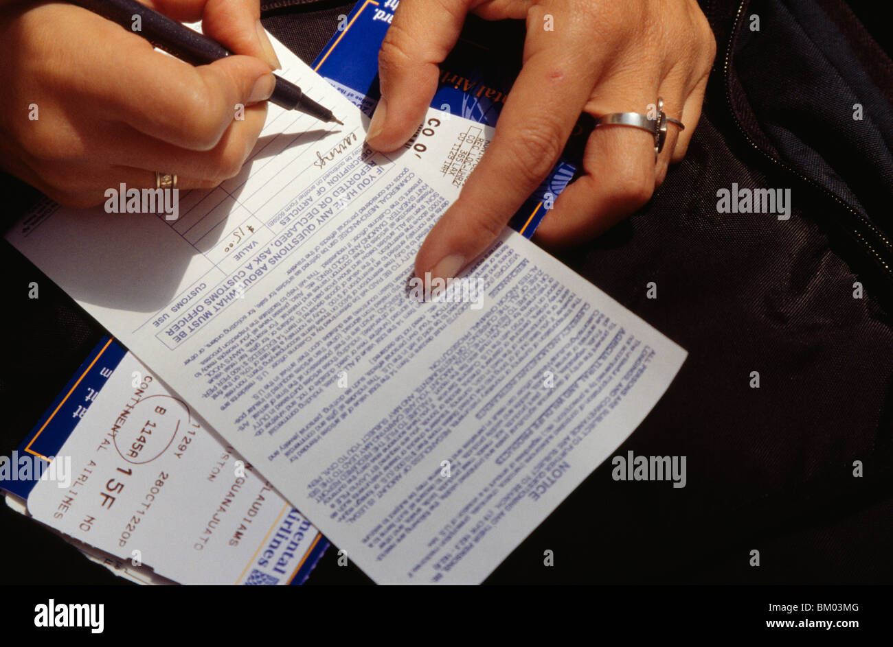 Woman signing customs form hi-res stock photography and images - Alamy