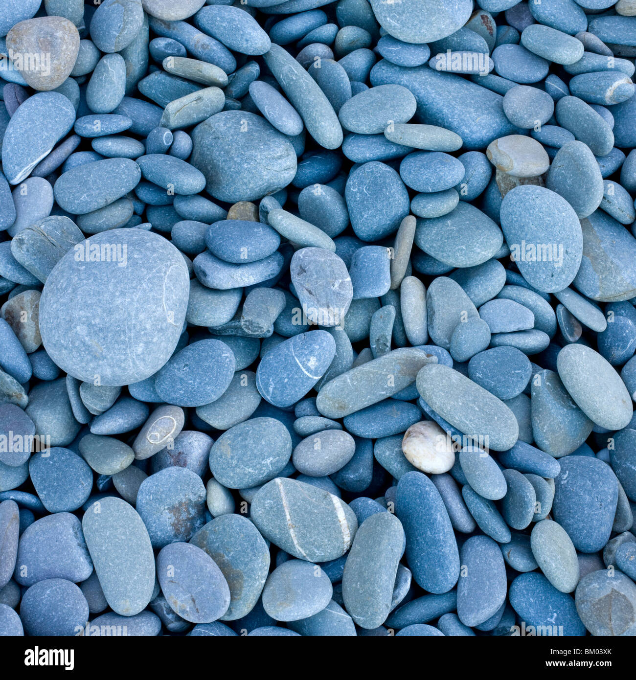 Beach abstract with blue pebbles Stock Photo - Alamy