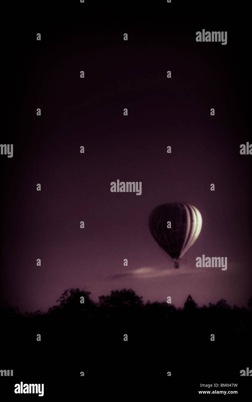 hot air balloon drifting in the night sky Stock Photo - Alamy
