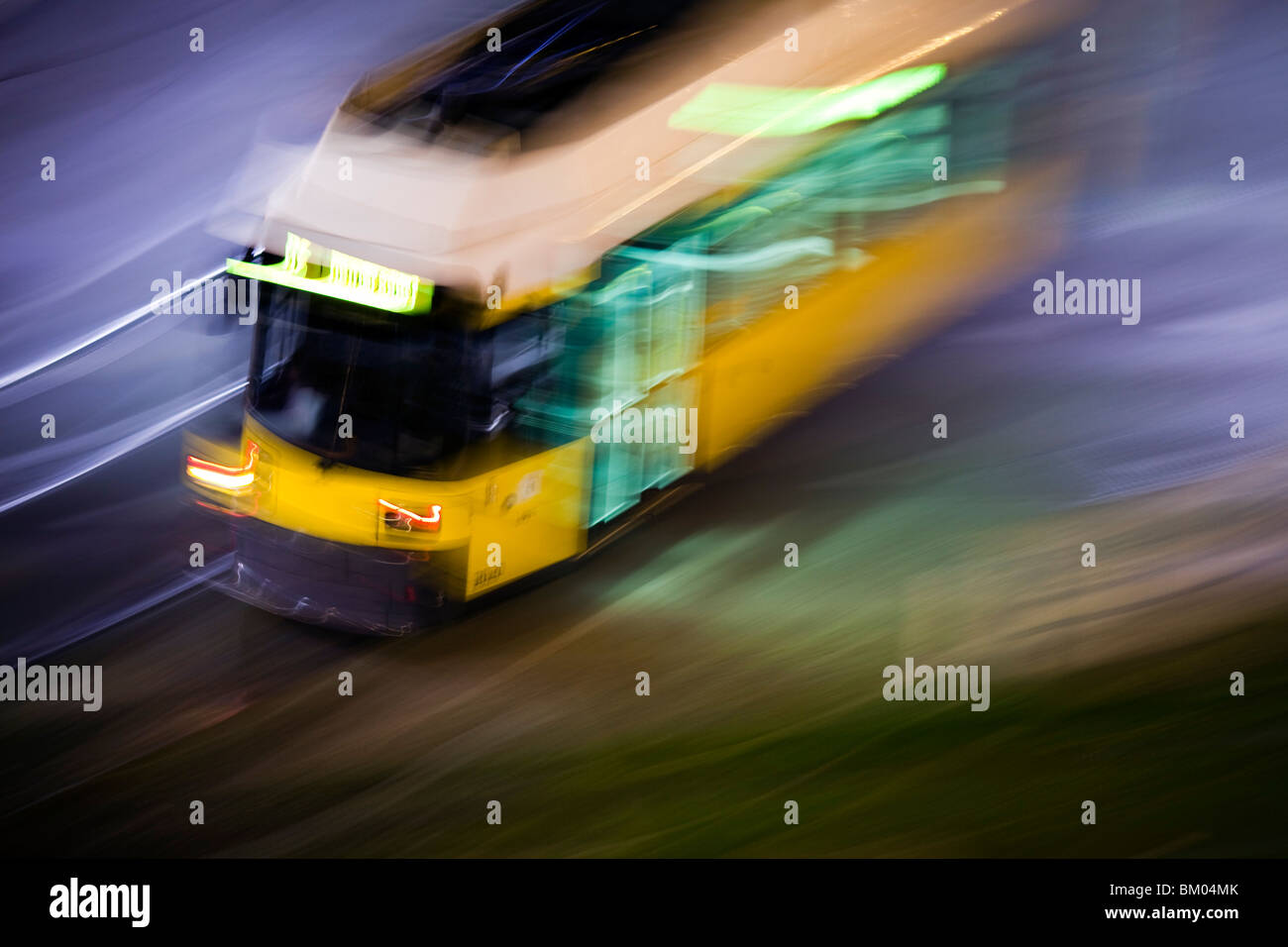 Panning shot of a tram by night, Berlin, Germany Stock Photo - Alamy