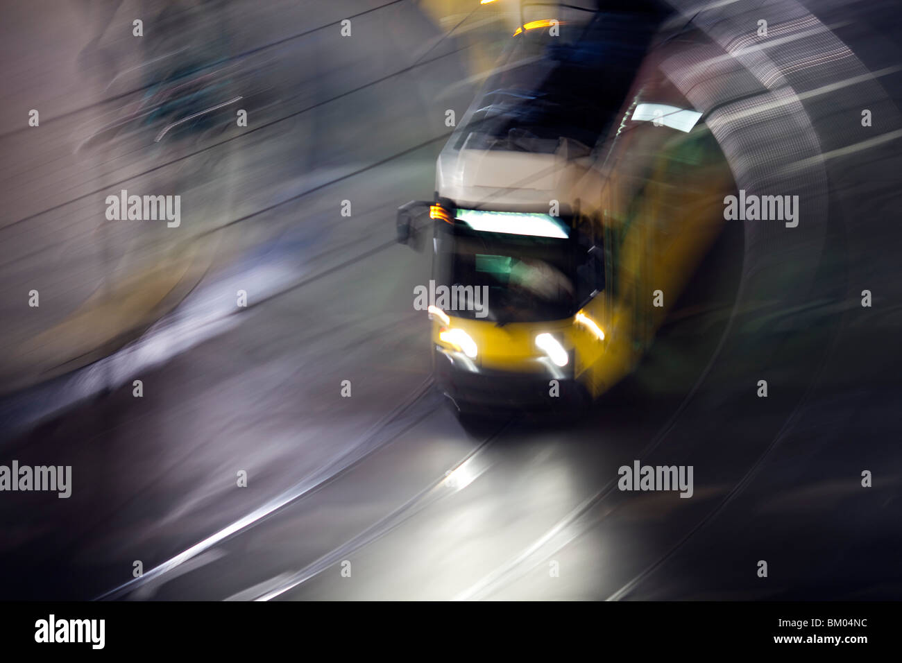 Panning shot of a tram by night, Berlin, Germany Stock Photo - Alamy