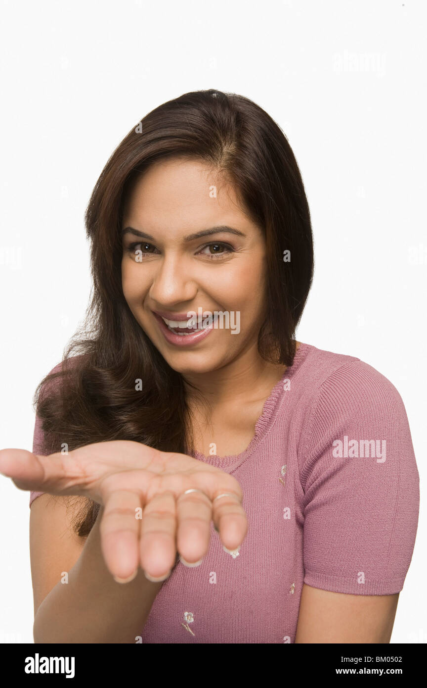 Portrait of a woman showing her empty hand and smiling Stock Photo - Alamy