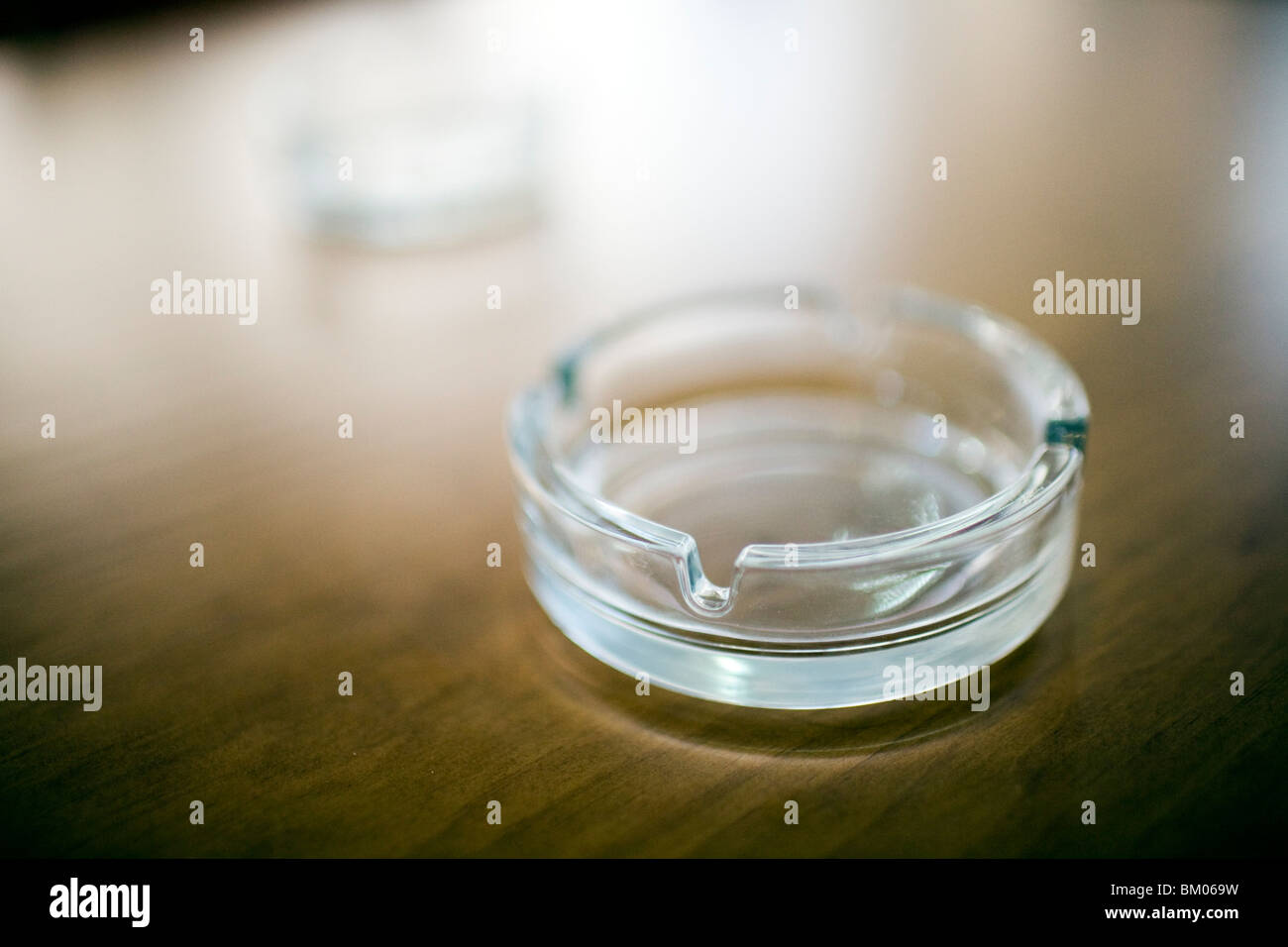 Empty glass ashtray on table Stock Photo - Alamy
