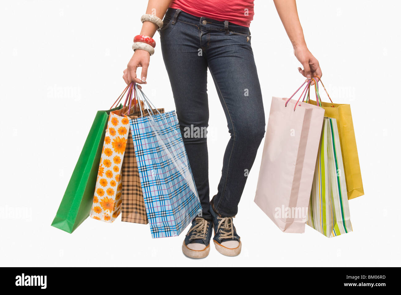 Low section view of a woman carrying shopping bags Stock Photo - Alamy