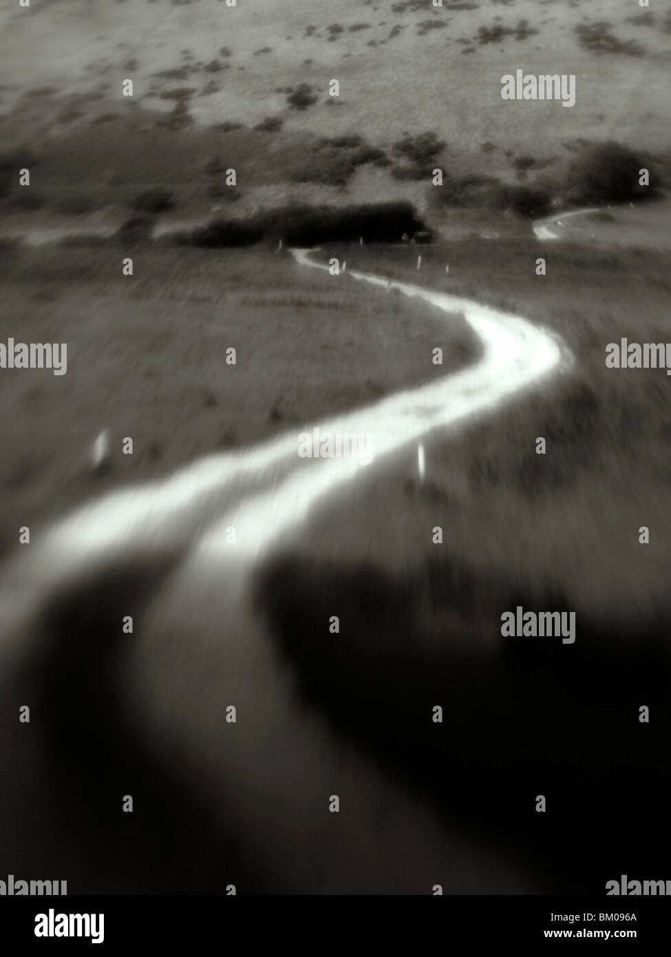 Sinuous Path winding its way across open land to a hillside Stock Photo ...