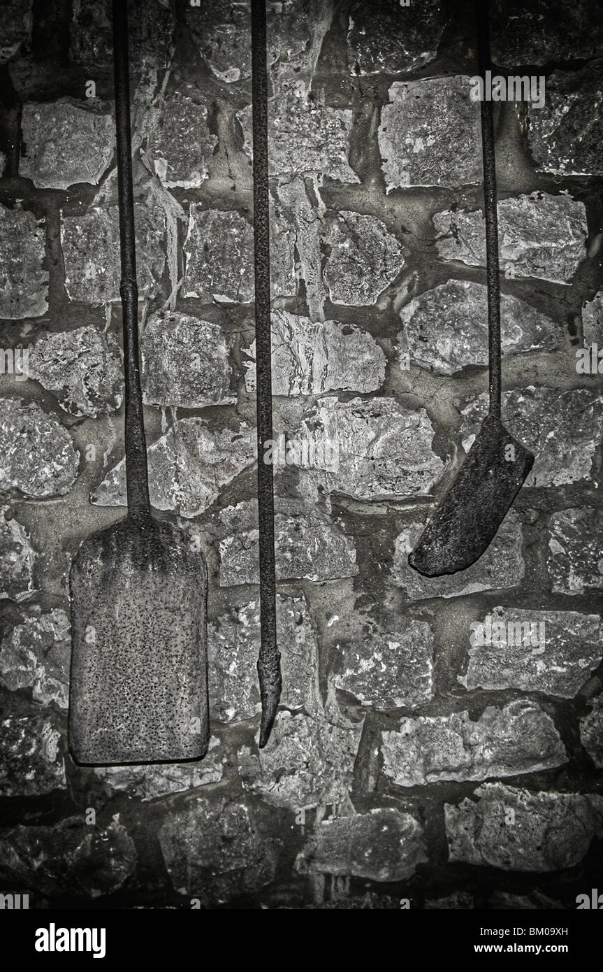 Old tools hanging against stone hi-res stock photography and images - Alamy