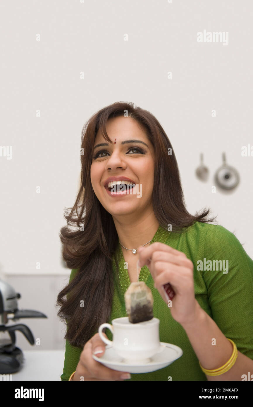 Woman drinking tea and laughing Stock Photo - Alamy