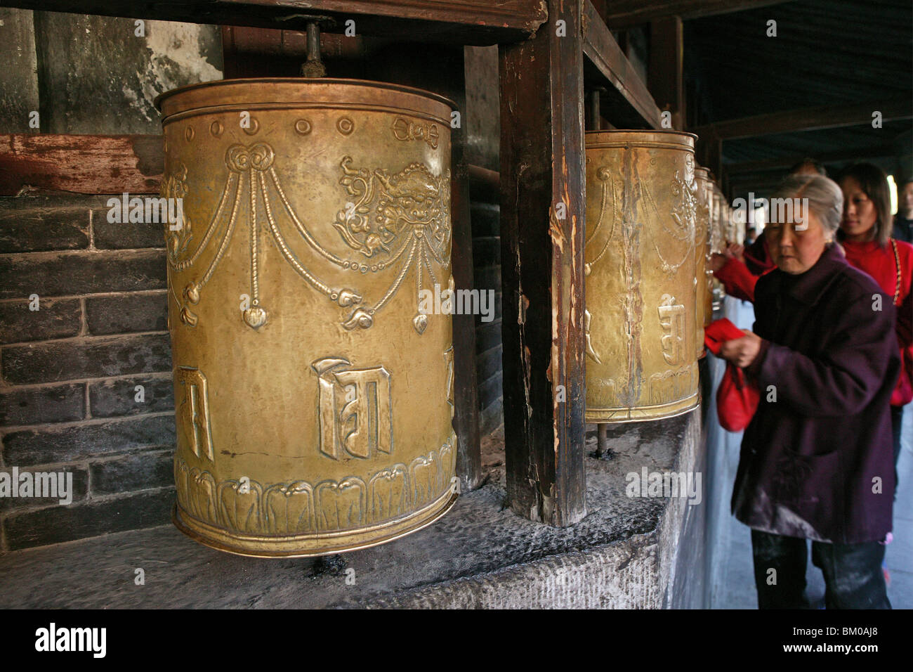 pilgrims circle and turn the prayer wheels at the base of the Great ...