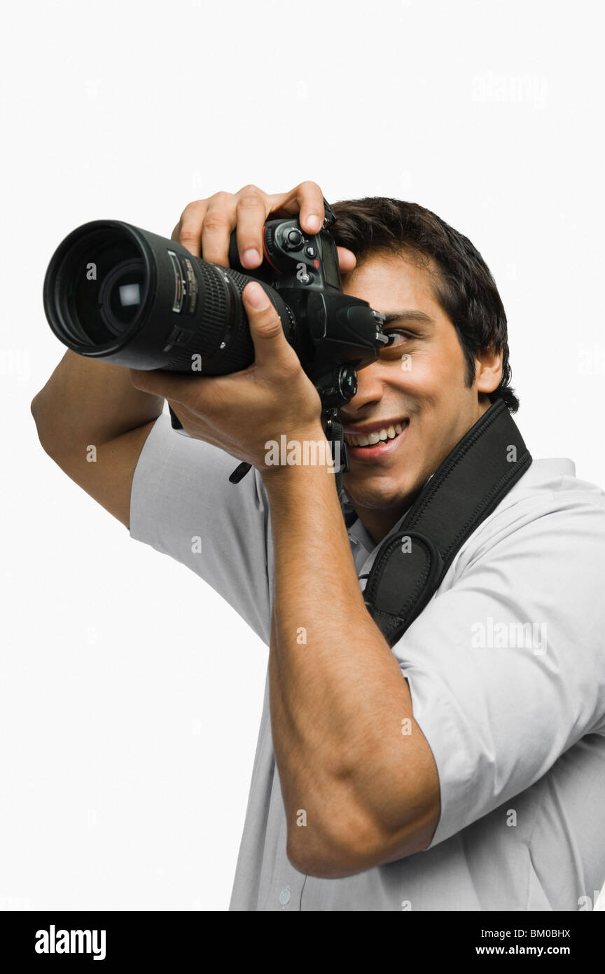 Photographer taking a picture with a digital camera Stock Photo - Alamy
