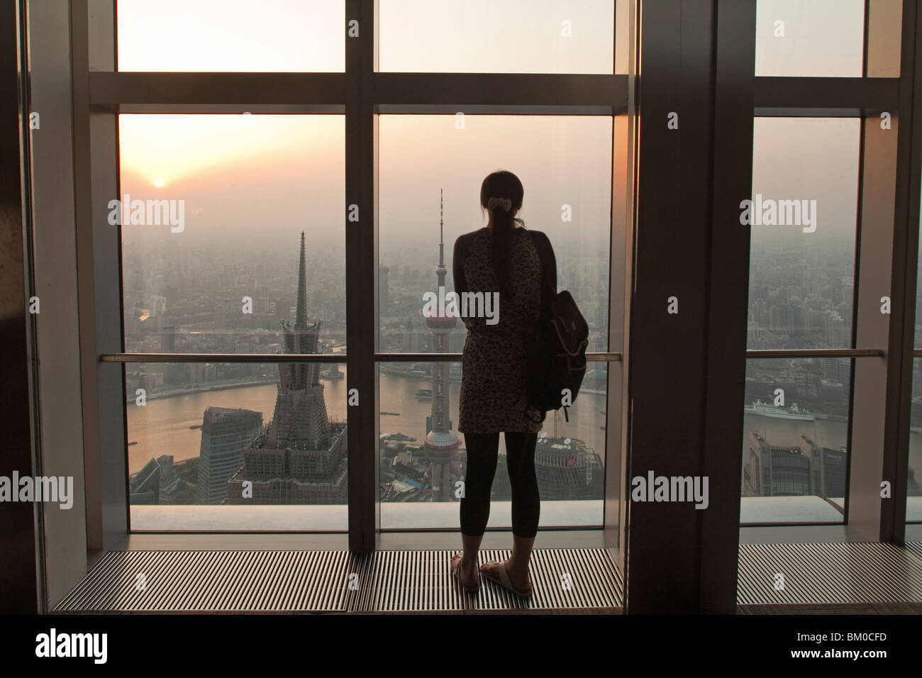 Back view woman on terrace hi-res stock photography and images - Alamy
