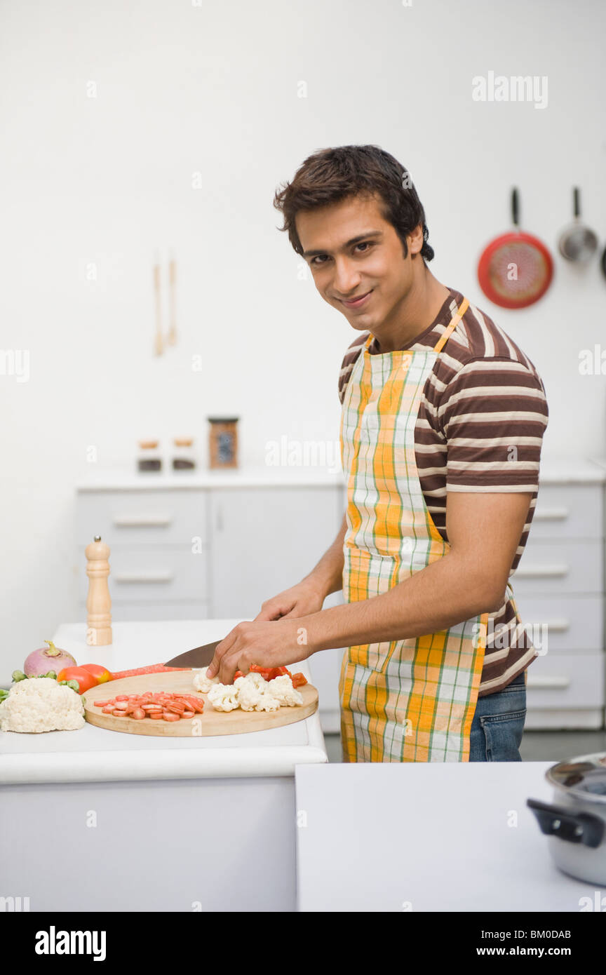 Man cutting vegetables in the kitchen Stock Photo - Alamy