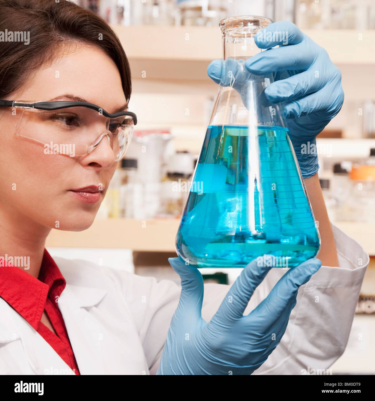 Female doctor holding a conical flask in a laboratory Stock Photo - Alamy
