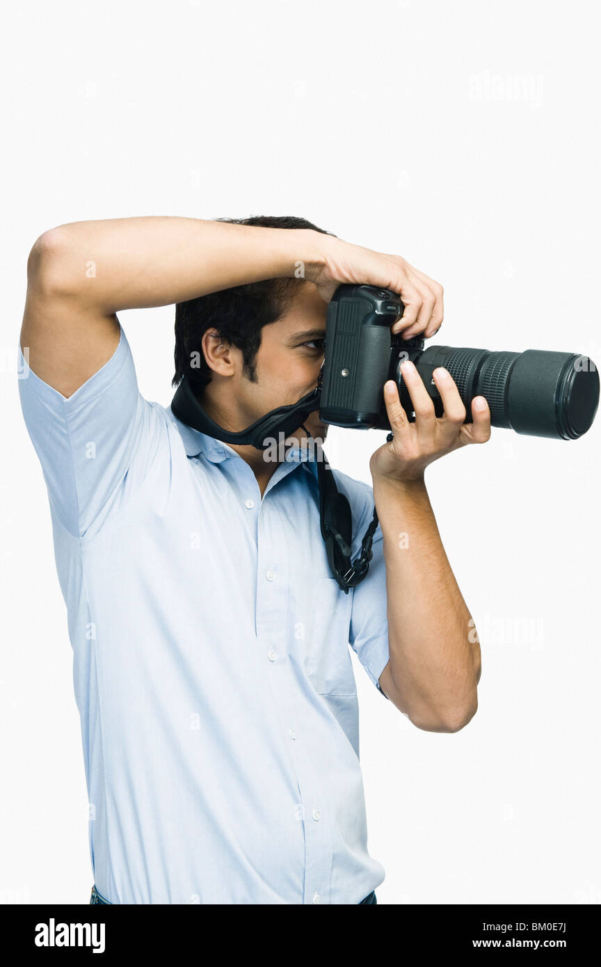 Photographer taking a picture with a digital camera Stock Photo - Alamy