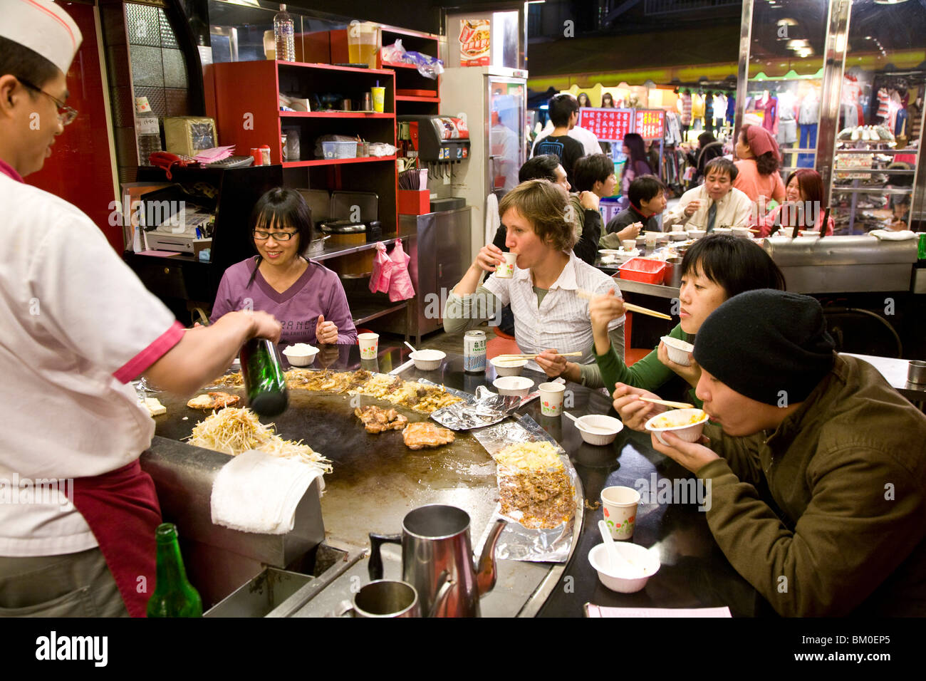 People in a Teppanyaki restaurant at Shilin night market, Taipei ...
