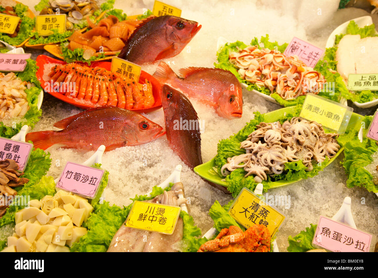 Tropical fish and seafood on ice at a restaurant, Chinese cuisine ...
