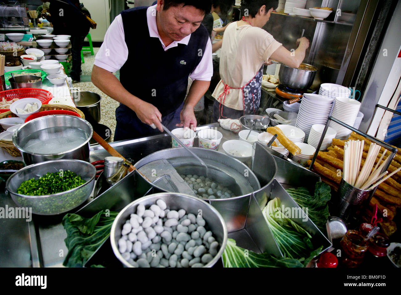 People cooking at a noodle cook shop at Tainan, Republic of China ...