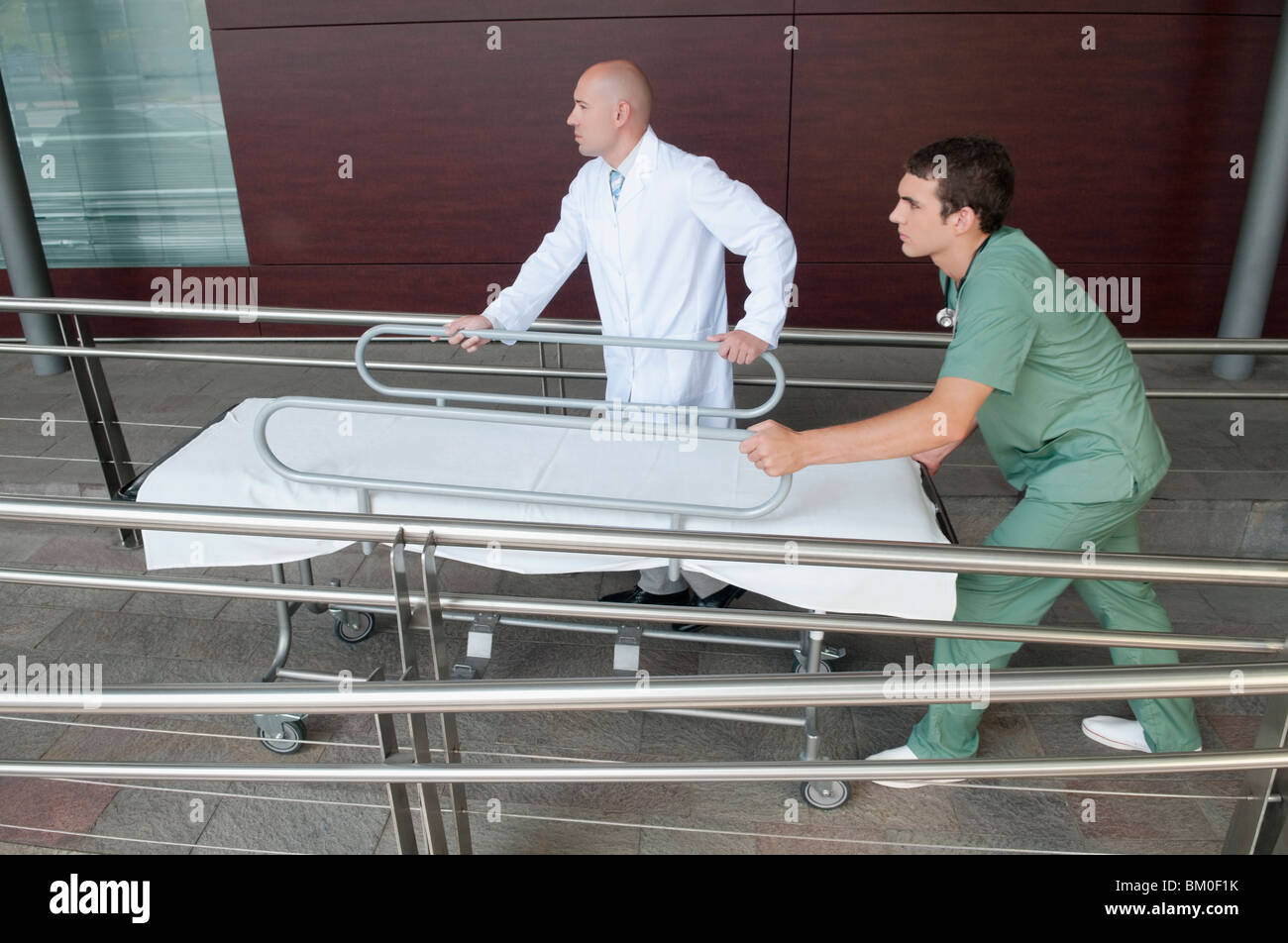 Doctor male nurse pushing hospital hi-res stock photography and images ...