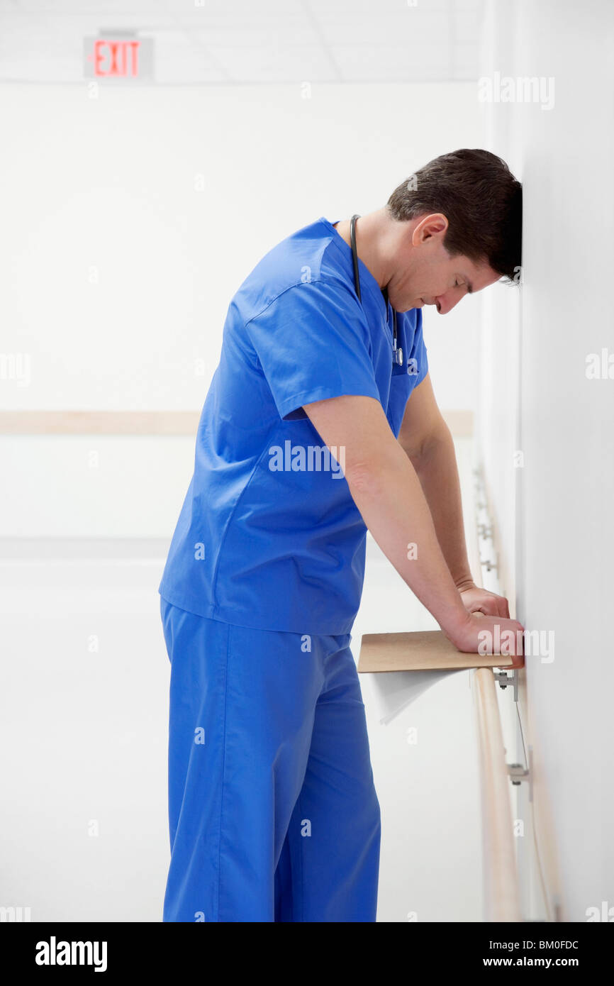 Doctor standing in a hospital and looking sad Stock Photo - Alamy