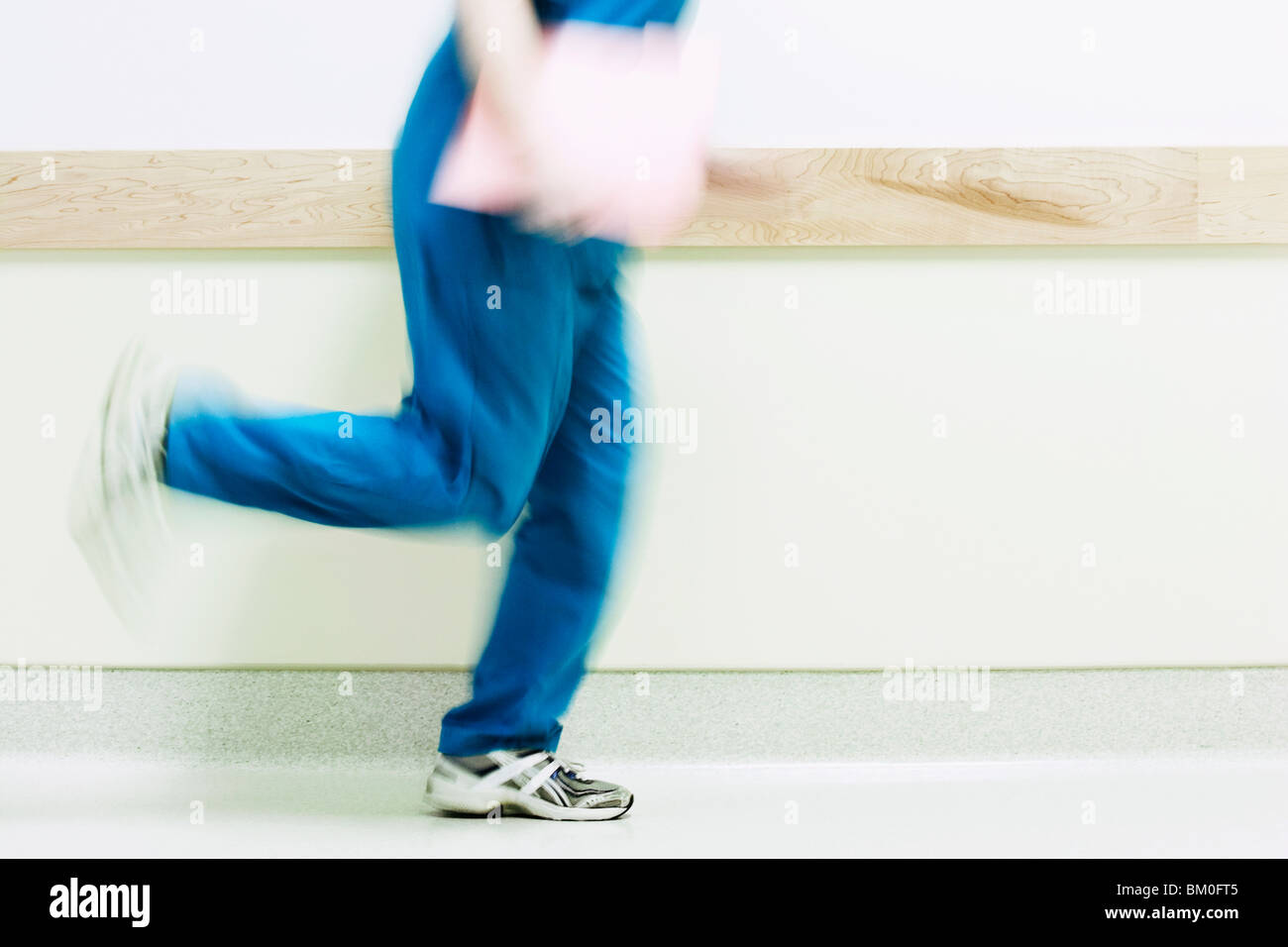 Female nurse running in a hospital Stock Photo - Alamy