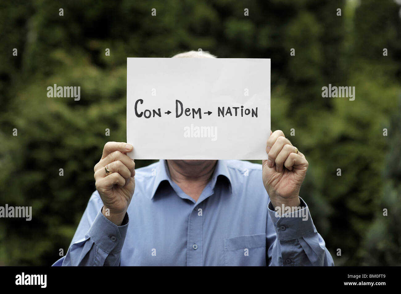man holding sign condemnation Stock Photo - Alamy