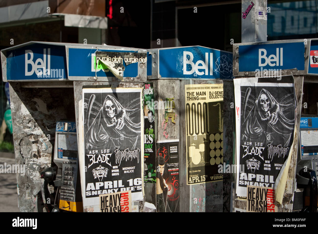 Bell payphone booths covered with flyer advertisements are seen in ...
