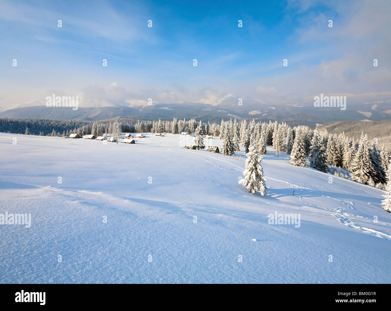 winter calm mountain landscape with sheds group and mount ridge behind ...
