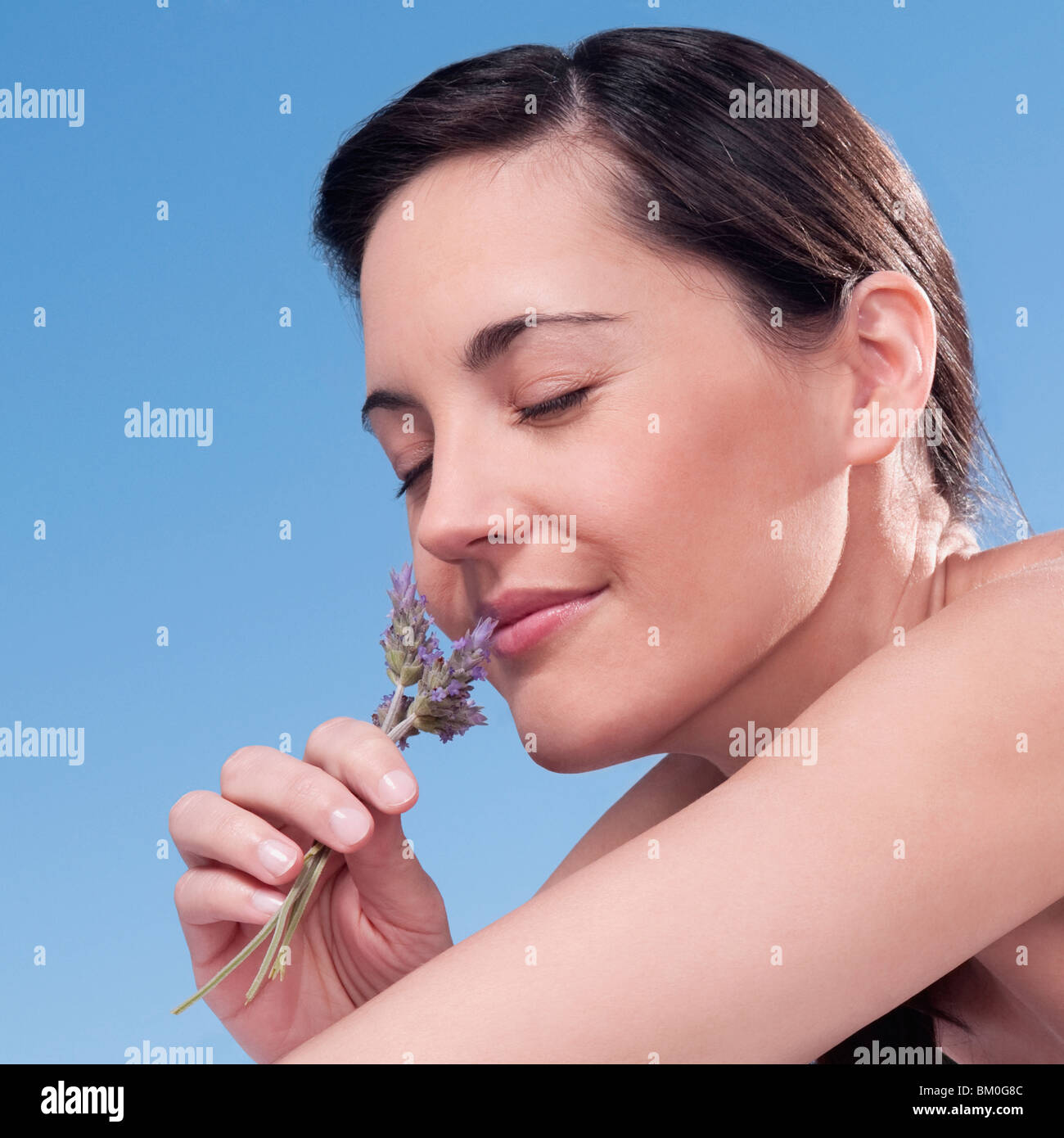 Close-up of a woman smelling lavender flowers Stock Photo - Alamy
