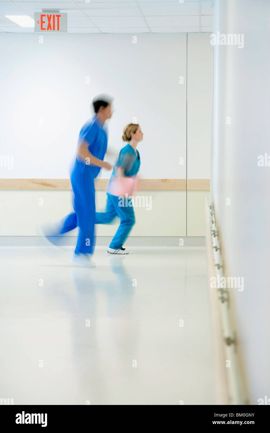 Two doctors running in a hospital corridor Stock Photo - Alamy