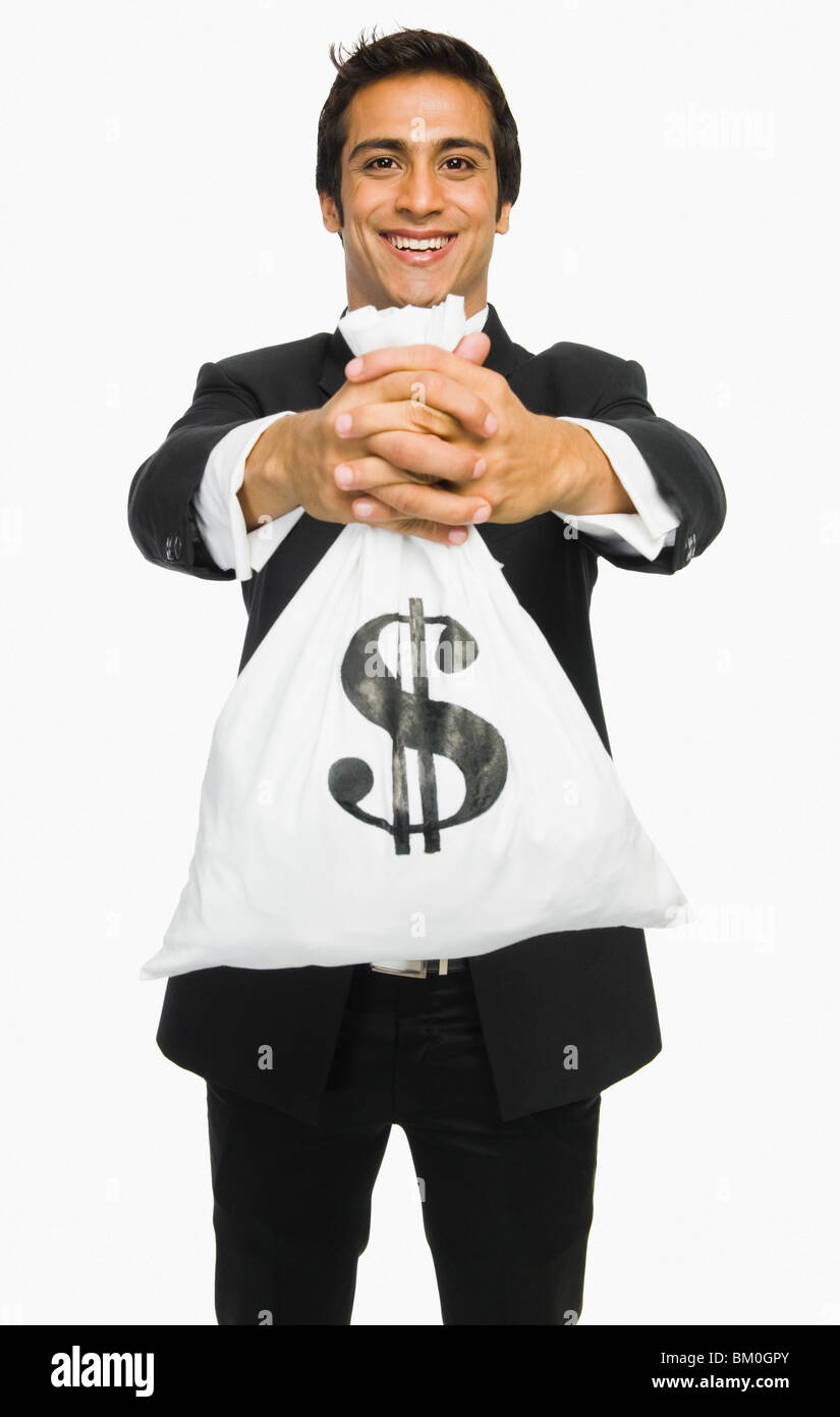 Portrait of a businessman holding a money bag Stock Photo - Alamy