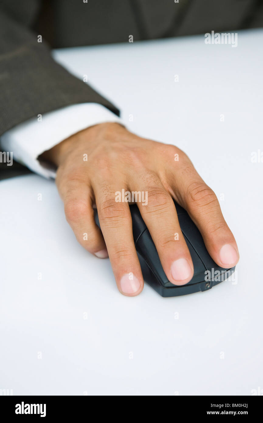 Businessman's hand using a cordless computer mouse Stock Photo - Alamy