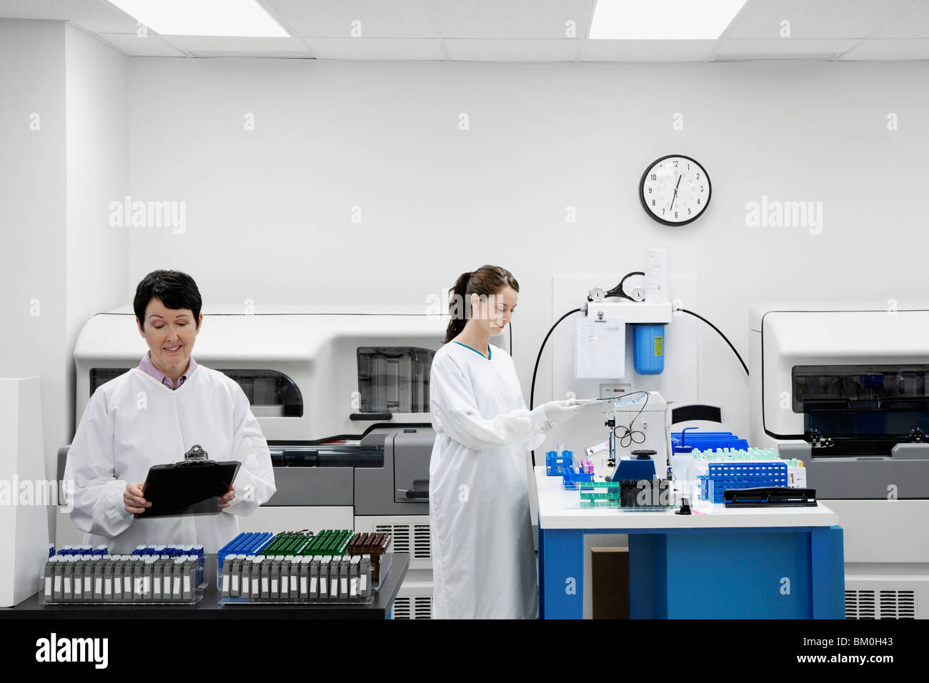 Female scientist examining a report in a laboratory hi-res stock ...