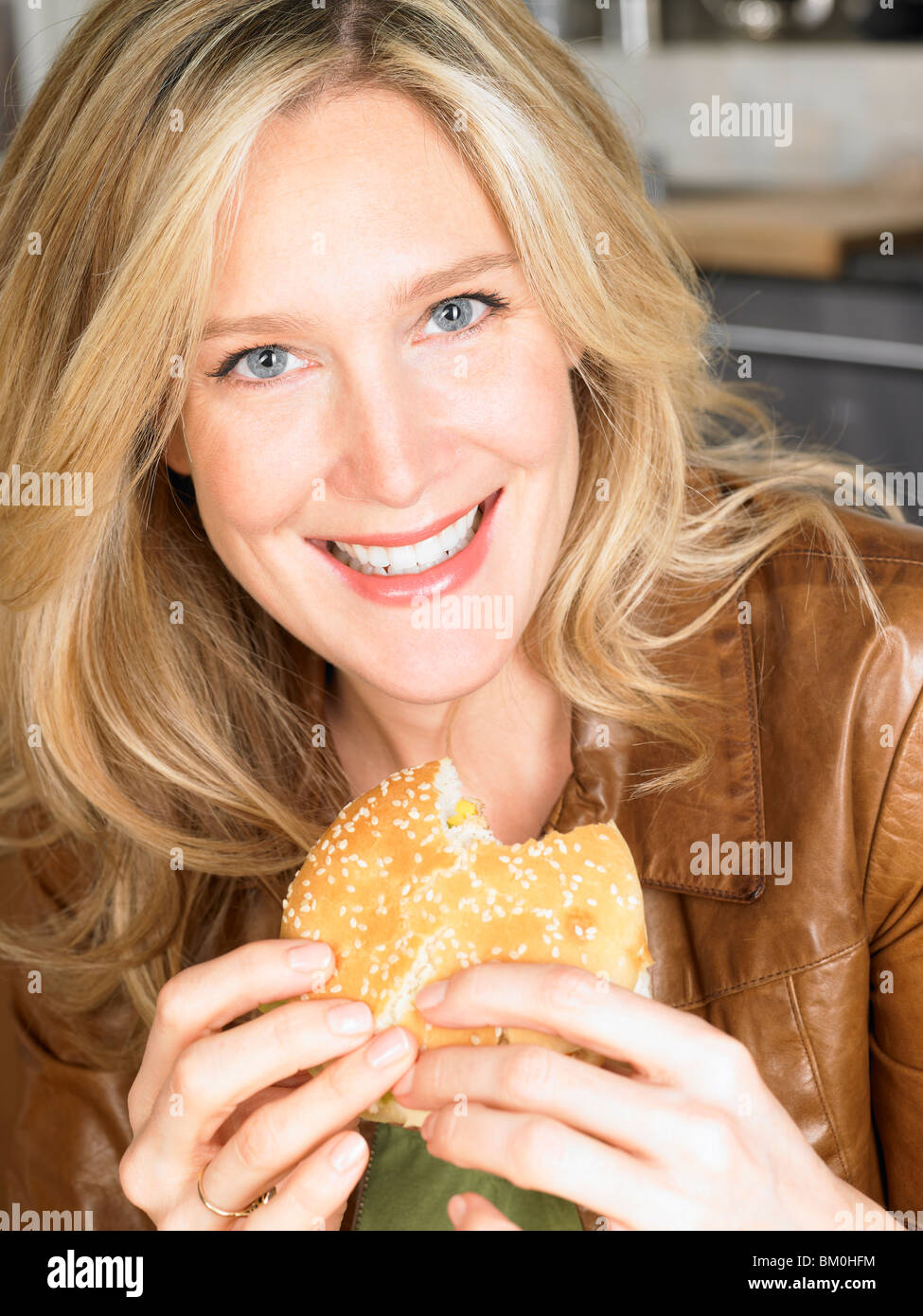 Blonde woman eating burger hi-res stock photography and images - Alamy