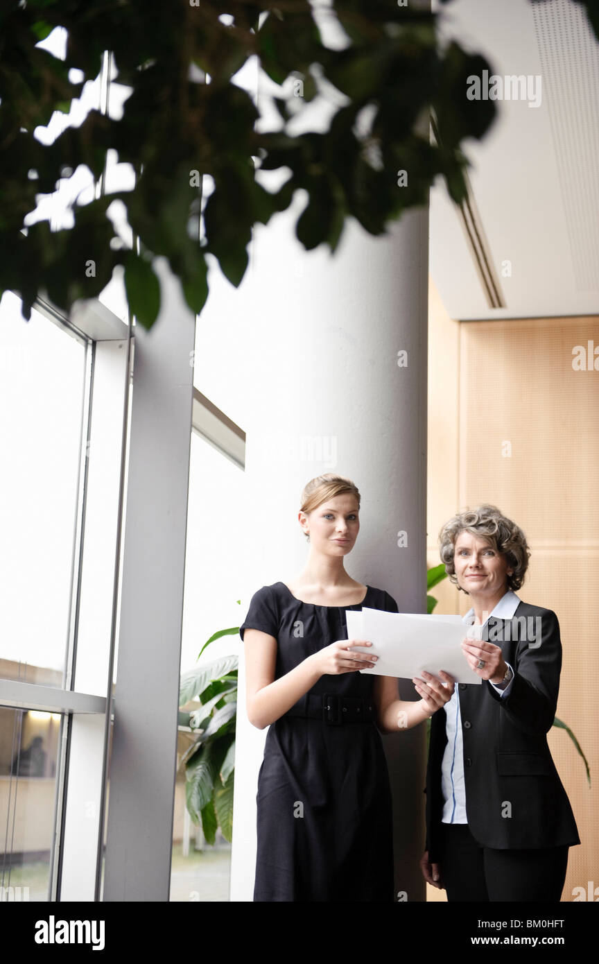Business people looking at paperwork Stock Photo - Alamy