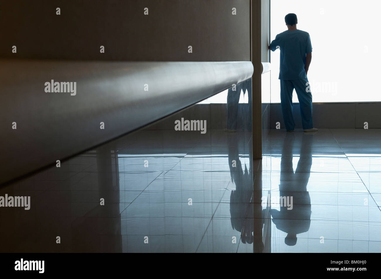 Surgeon looking through a window in a hospital Stock Photo - Alamy