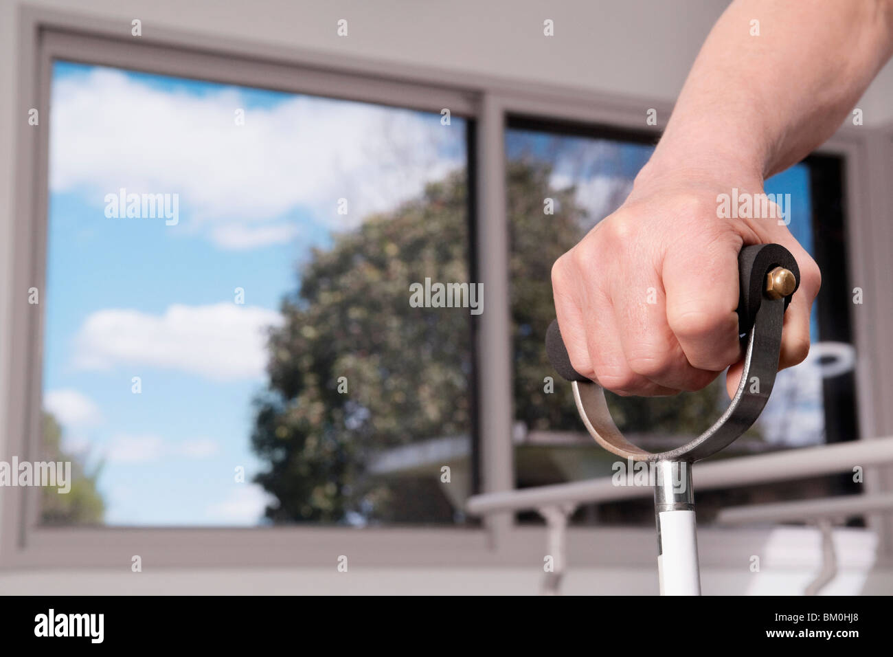 Human hand holding a crutch Stock Photo - Alamy