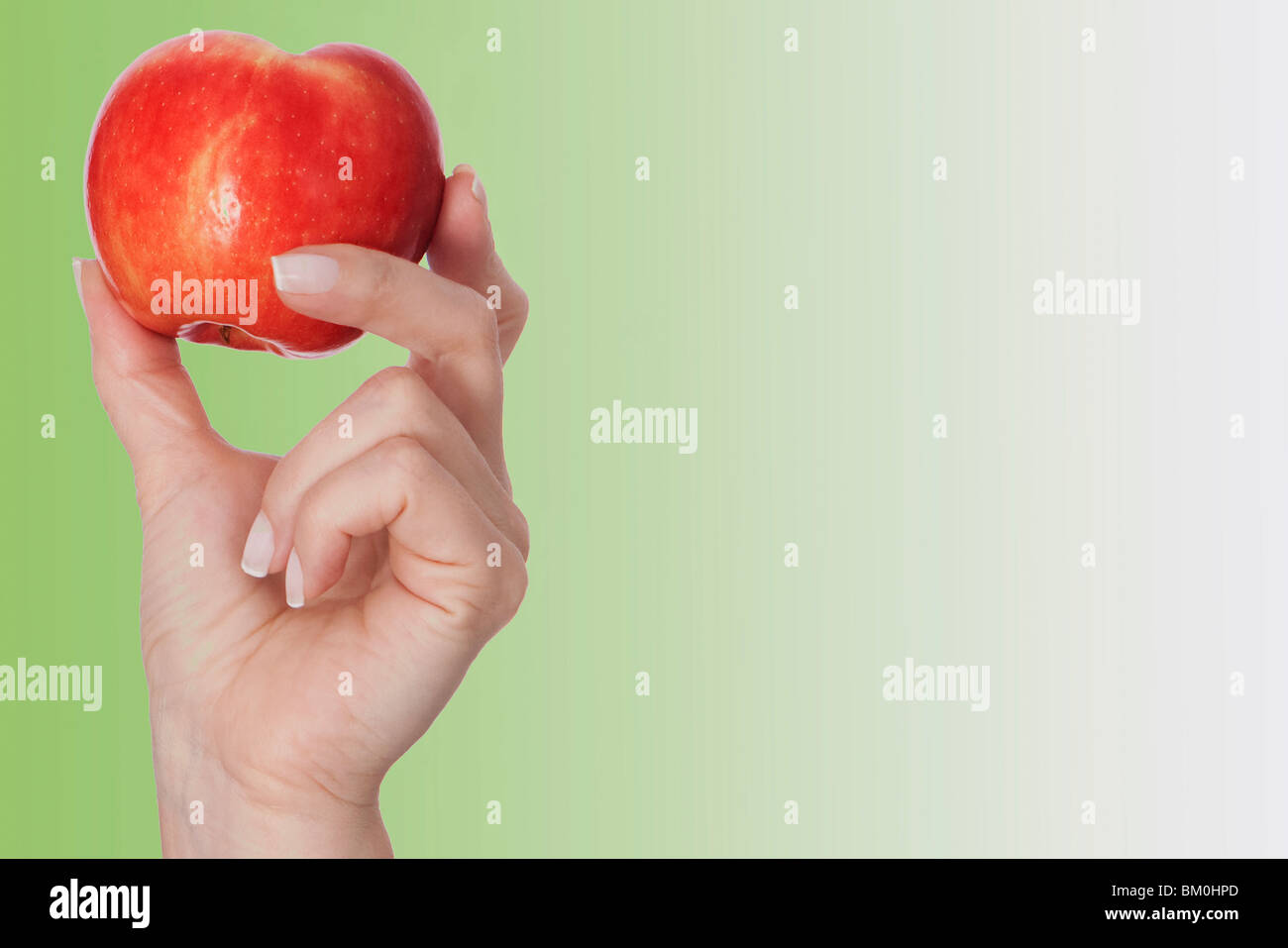 Person's hand holding an apple Stock Photo - Alamy