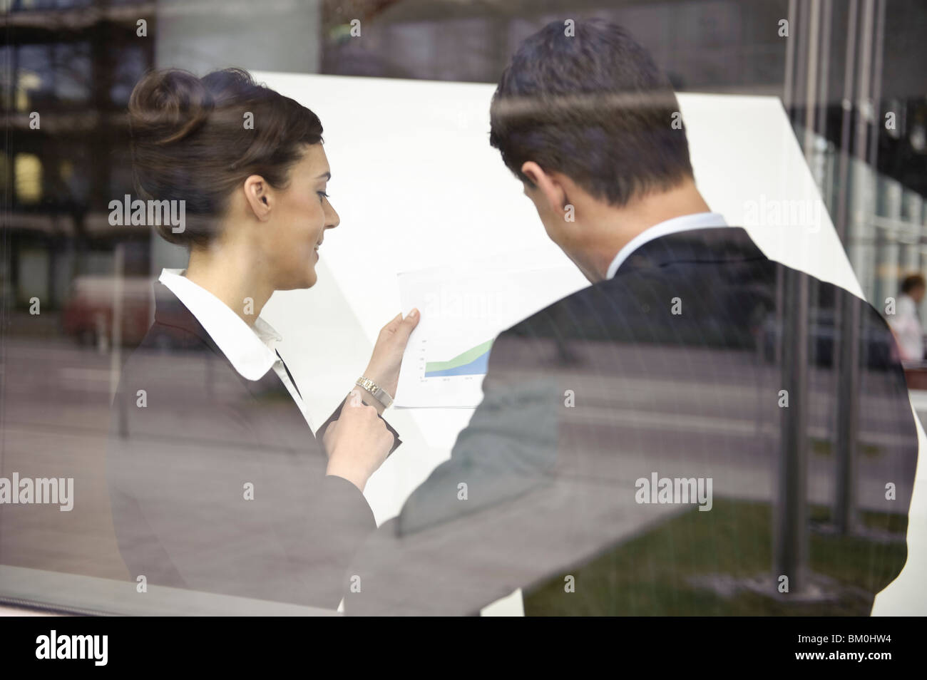 Business people looking at paperwork Stock Photo - Alamy