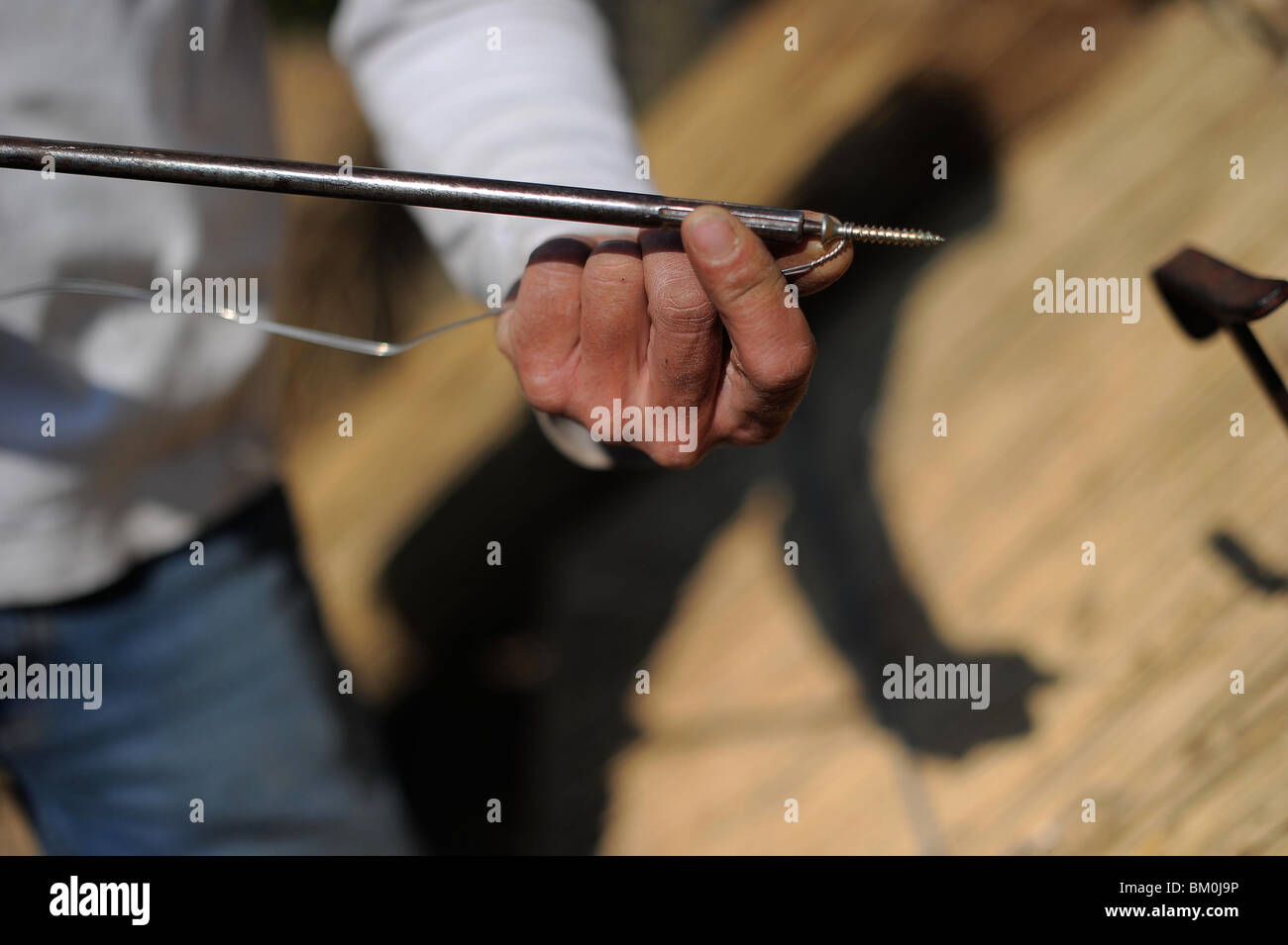 Glen Holloway, a master thatcher pictured working on a thatched roof ...