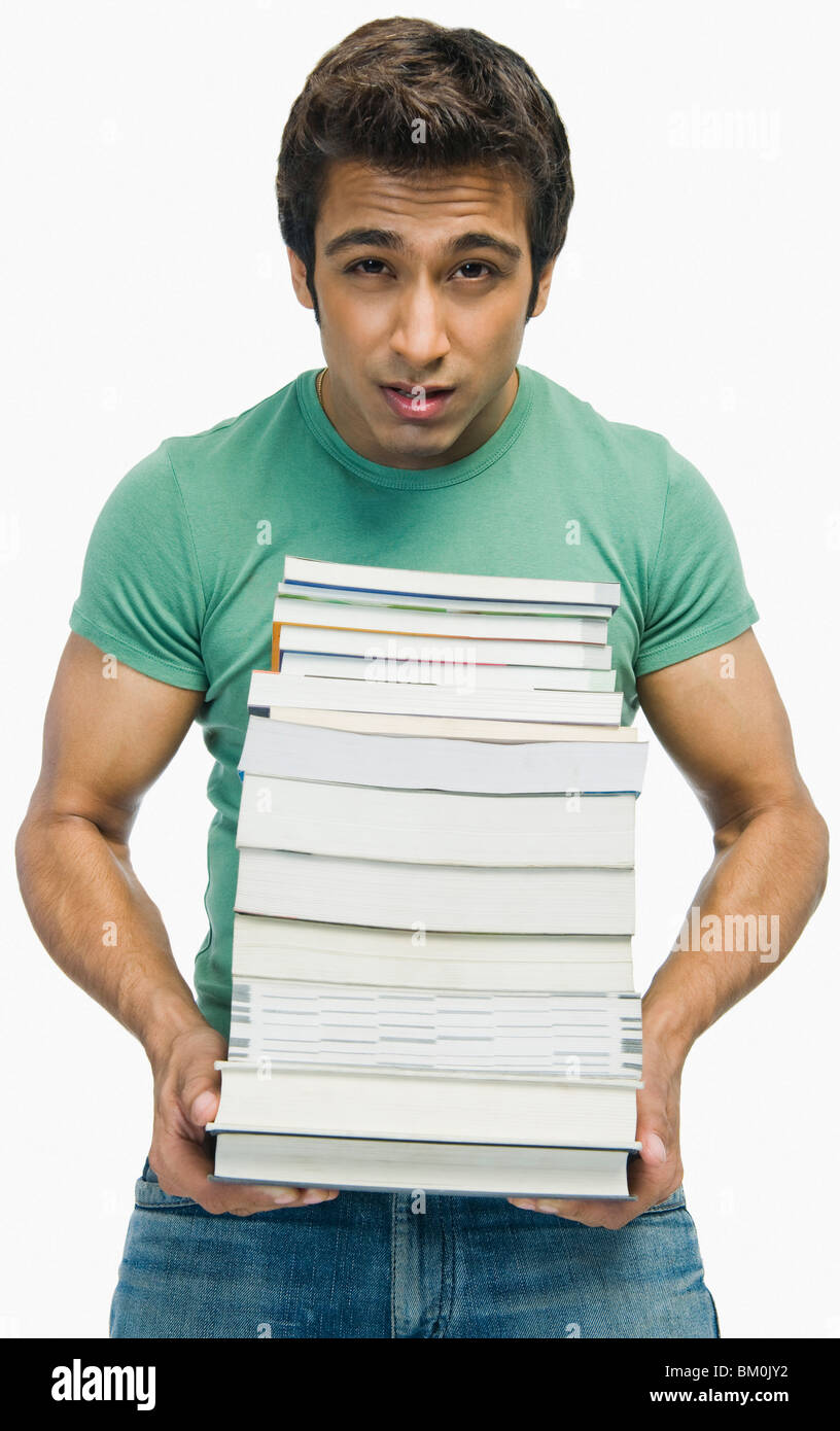 Man holding stack books hi-res stock photography and images - Alamy
