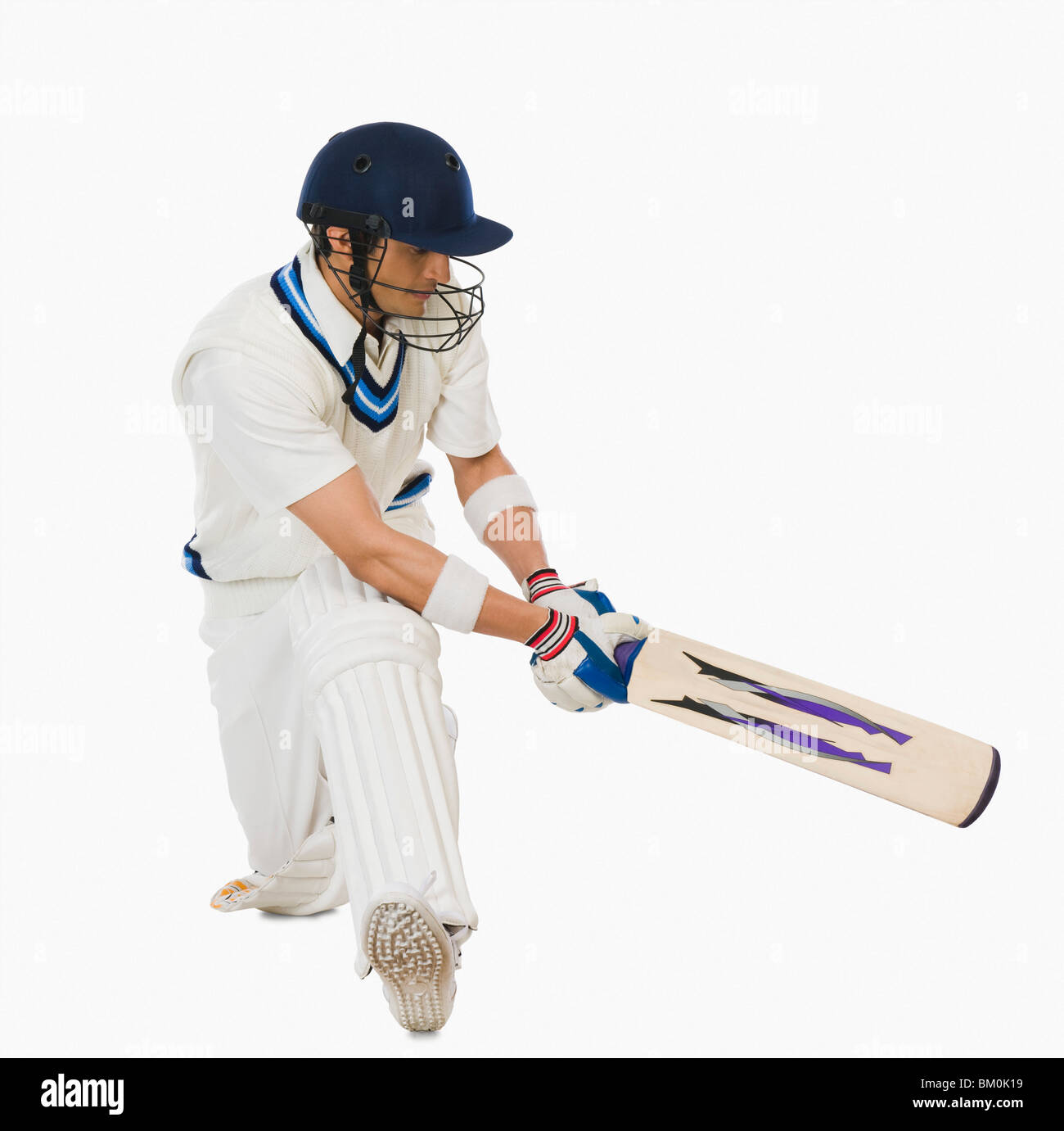 Cricket batsman playing a sweep shot Stock Photo - Alamy