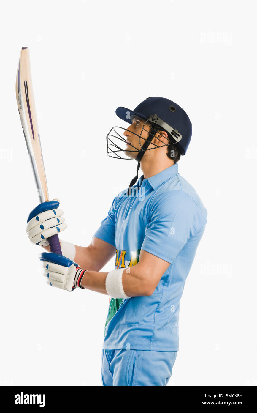 Cricket batsman looking at his bat Stock Photo - Alamy