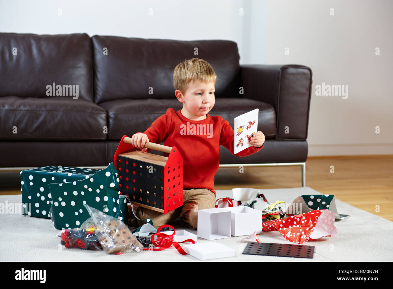 Young boy opening presents Stock Photo - Alamy
