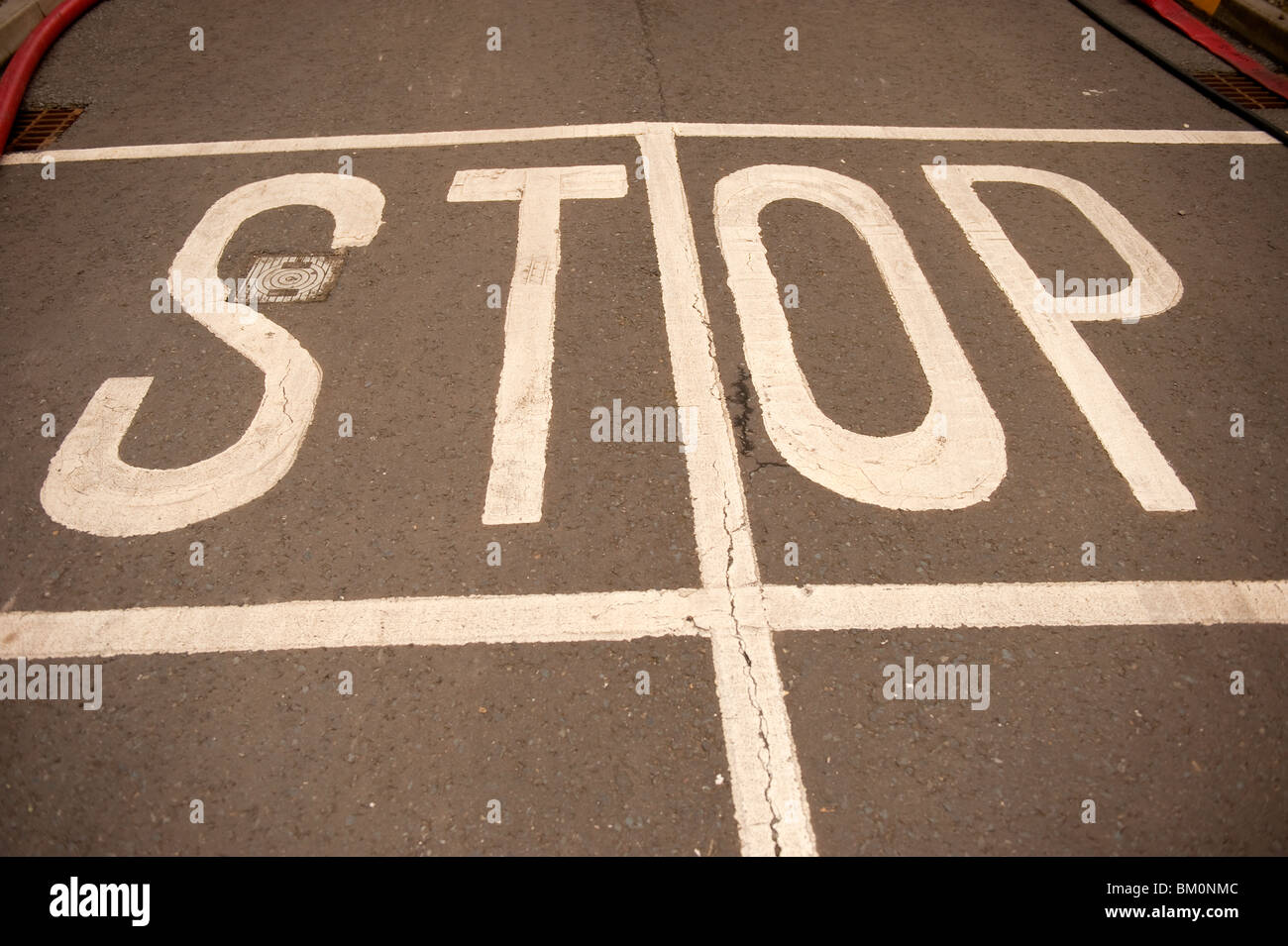 Stop sign painted on road Stock Photo - Alamy